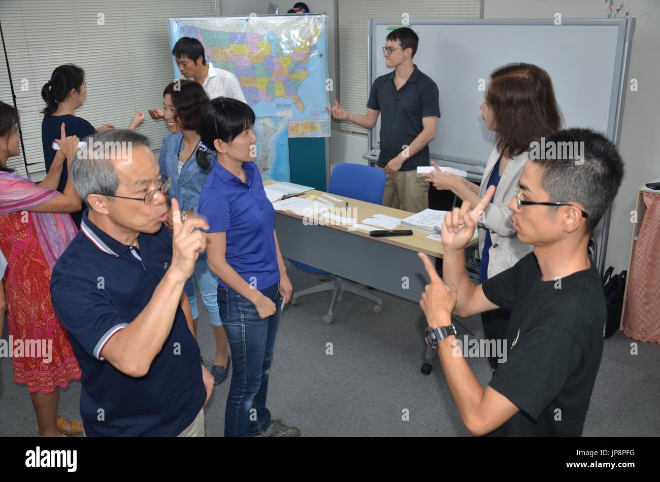 Japanese students practice using American sign language during a course ...