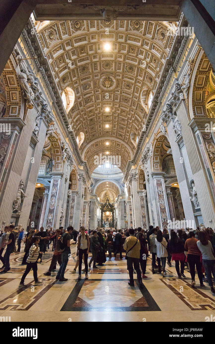 Vertical view of tourists inside St Peter's Basilica at the Vatican in ...