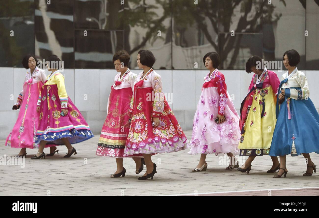 North Korean women in colorful traditional clothes walk on a Pyongyang ...