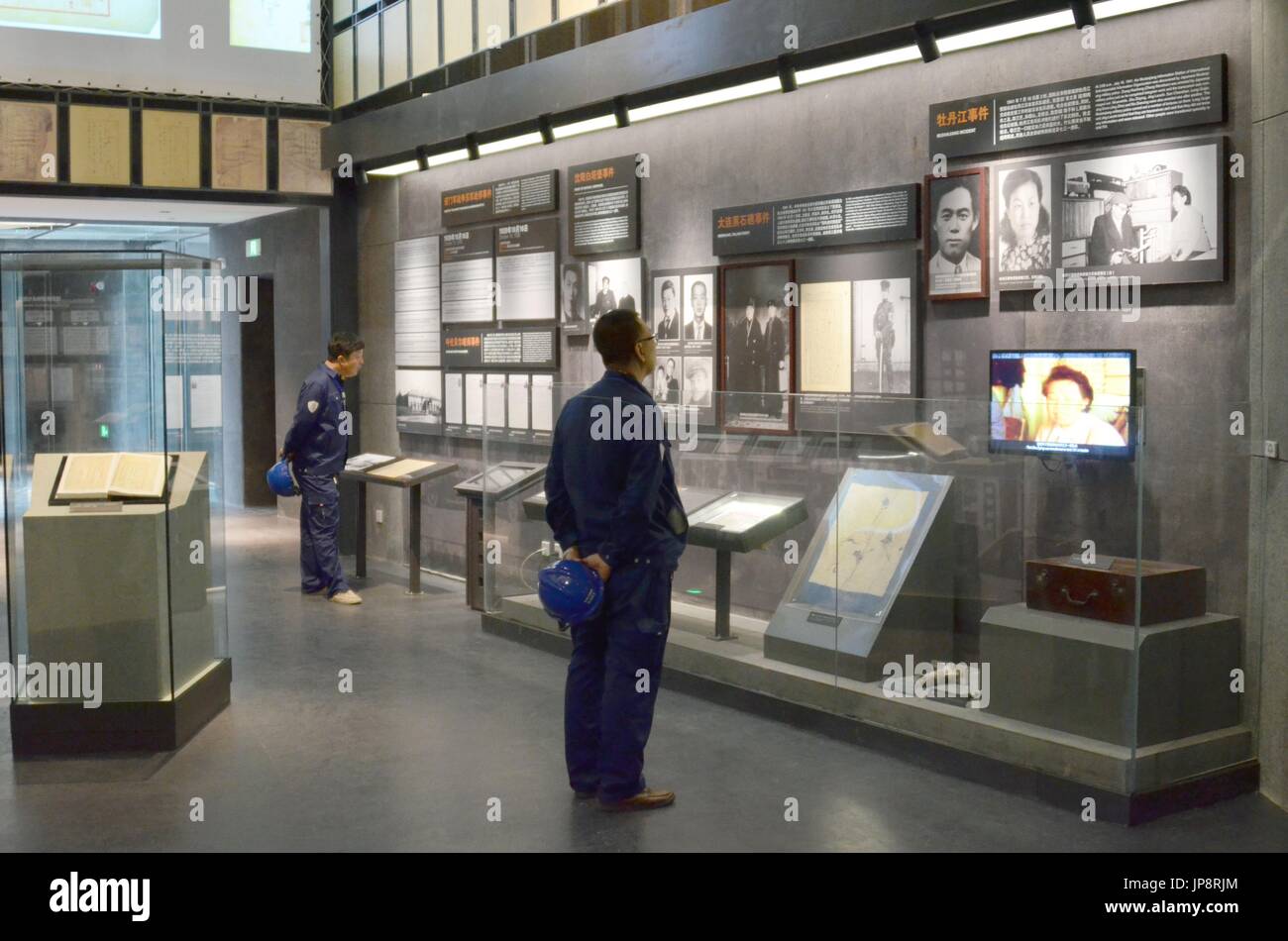 Visitors look at exhibits at a newly opened building of Unit 731 Museum ...
