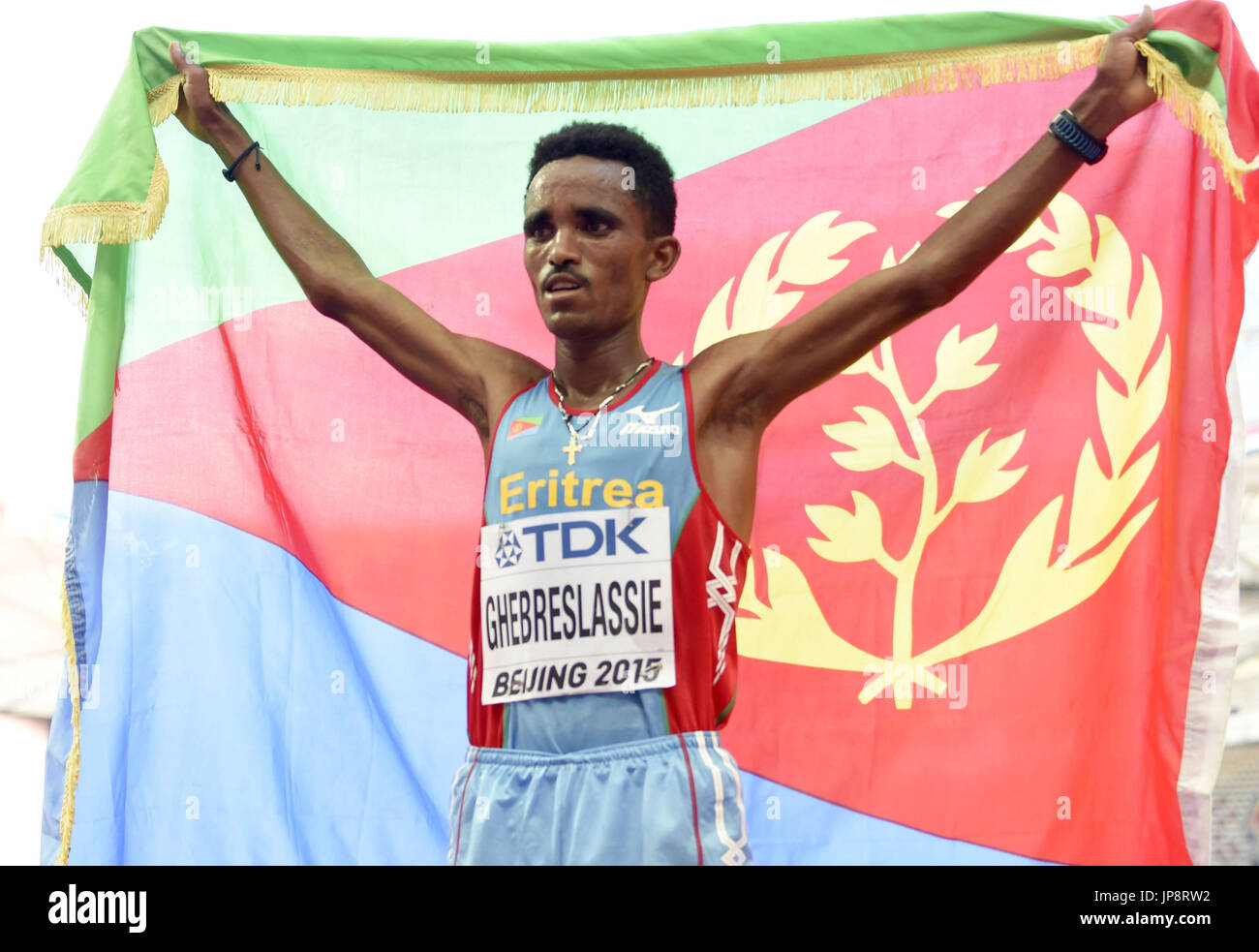 Ghirmay Ghebreslassie hoists Eritrea's flag after winning the men's marathon at the World ...