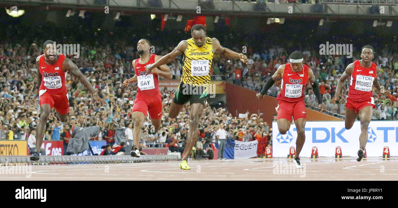 Usain Bolt (C) crosses the finish line to win gold in the men's 100 ...