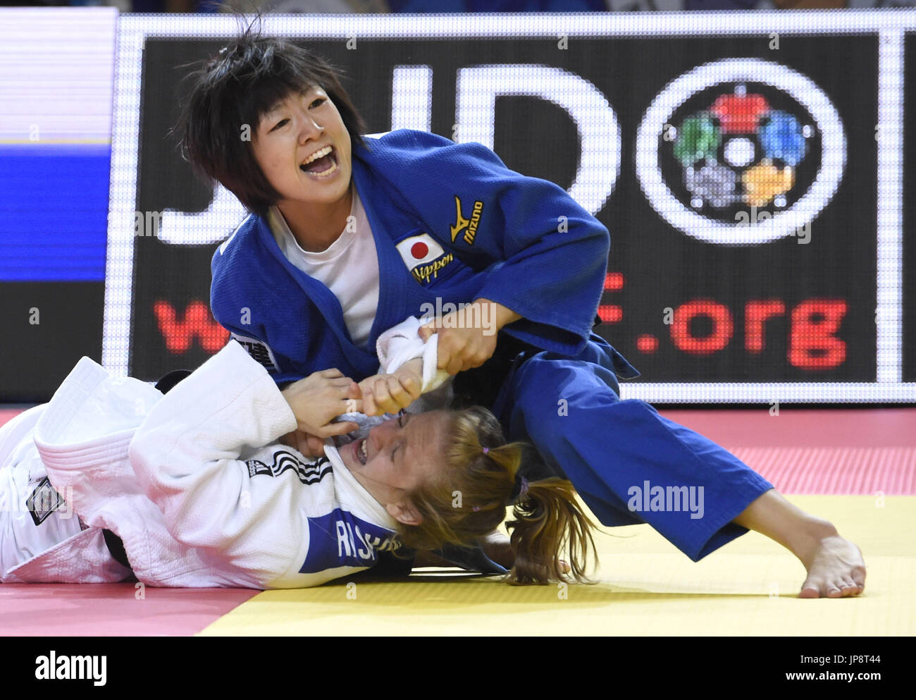 Haruna Asami (R) of Japan takes down Shira Rishony of Israel in the ...
