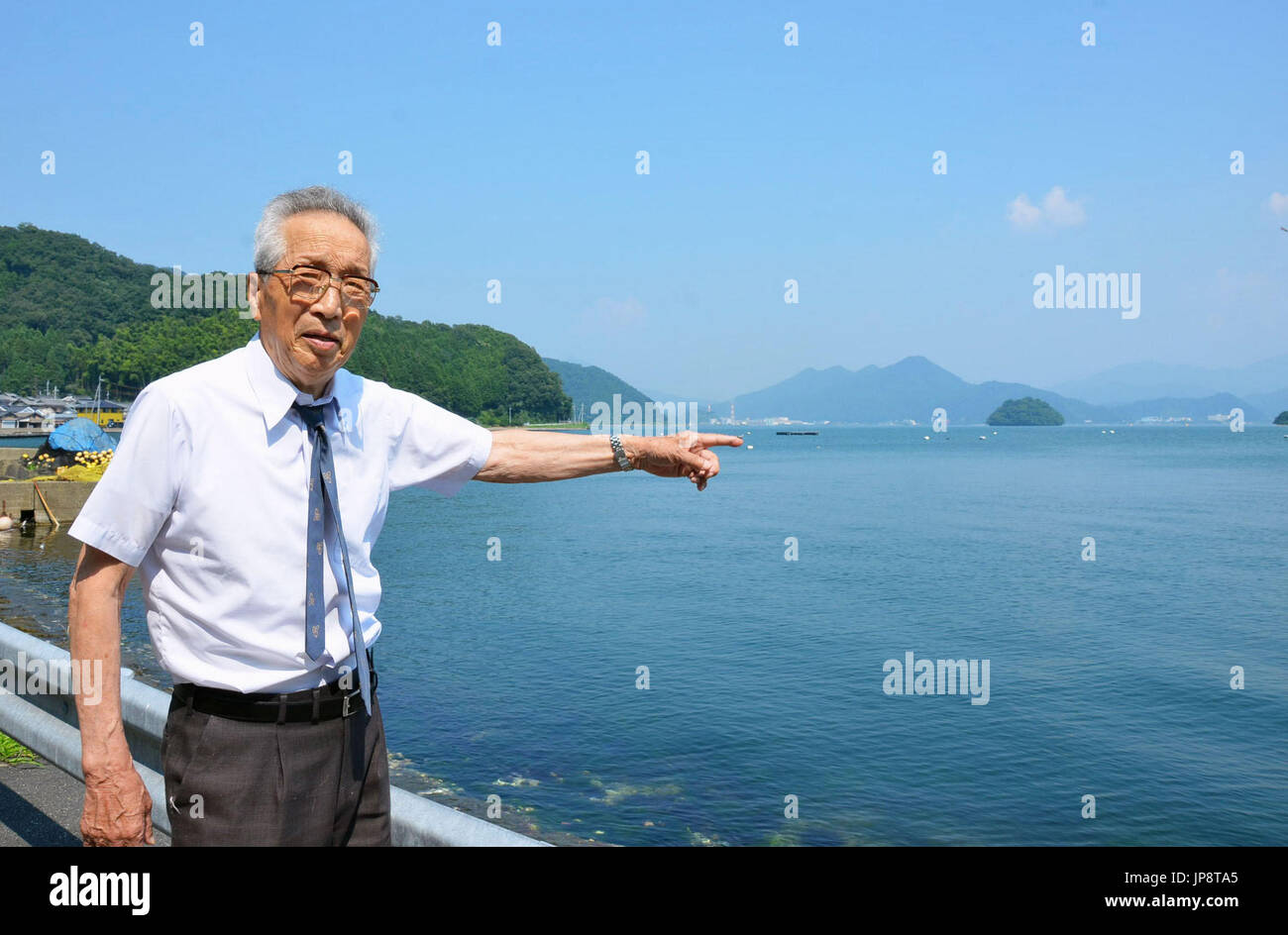 Akio Tosa points to the site of the 1945 sinking of a Japanese naval ...