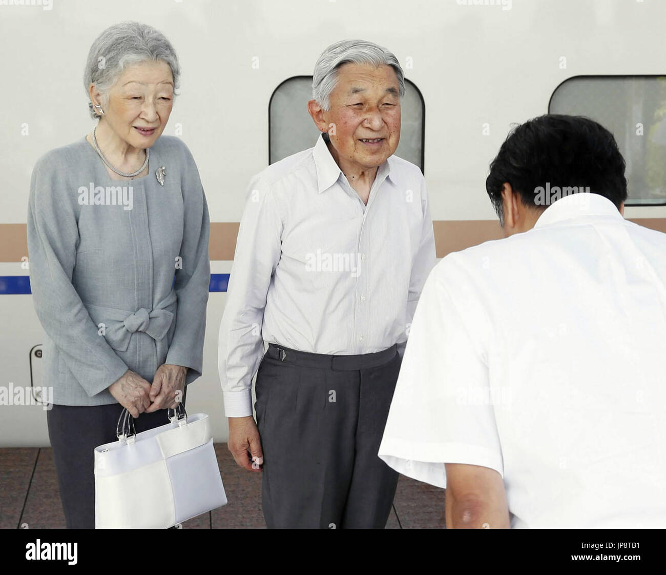 Emperor Akihito (C) and Empress Michiko (L) are greeted by Nagano Gov ...