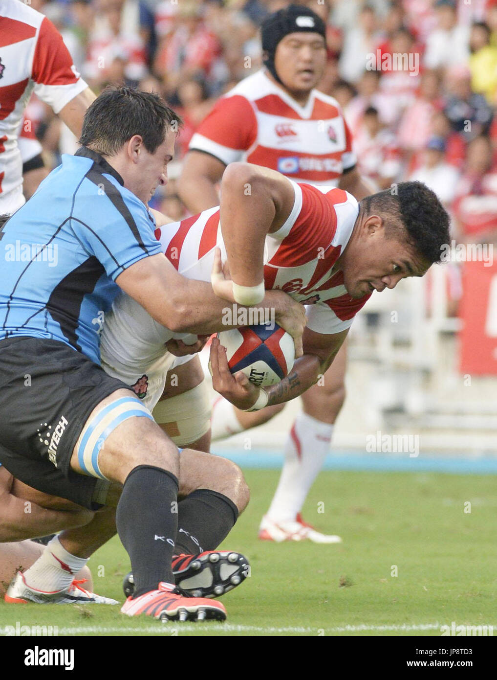 Loose forward Hendrik Tui (C) of Japan makes the opening try in the ...