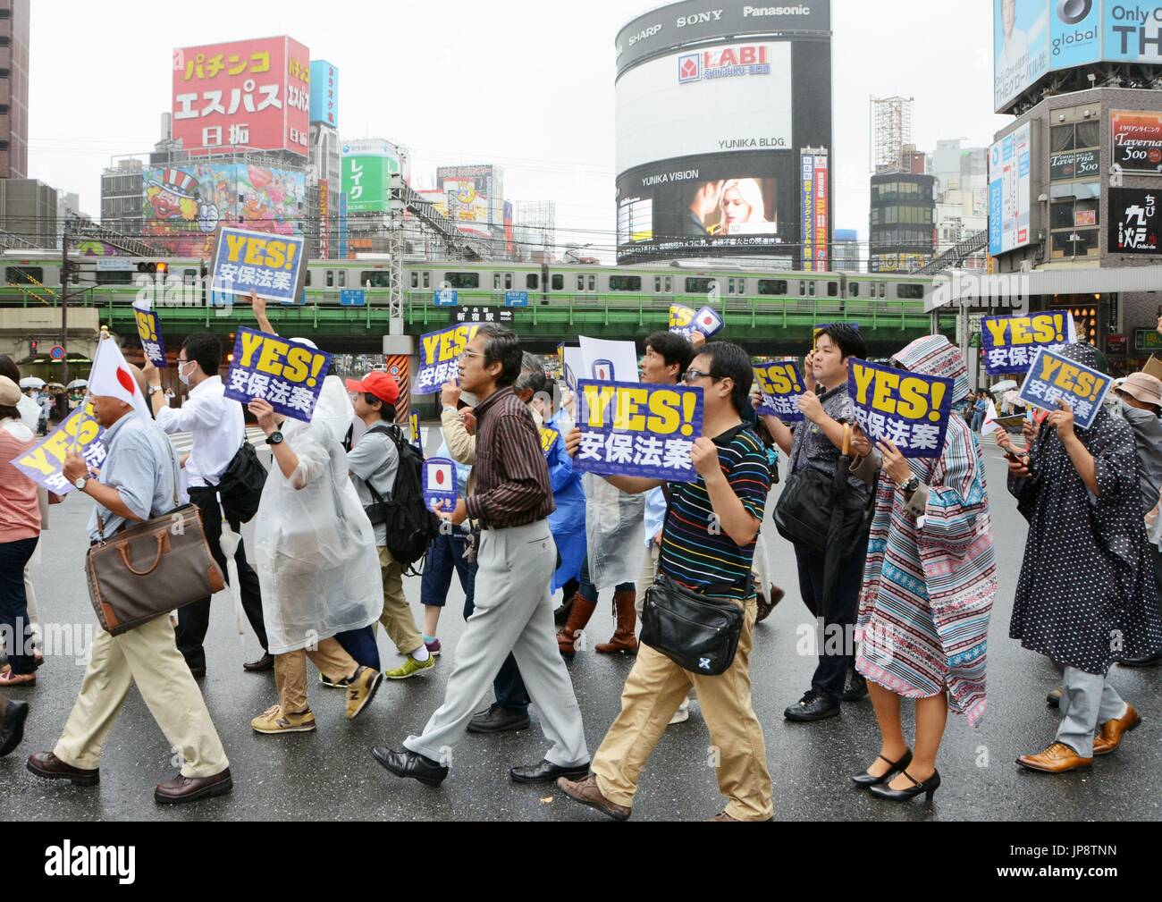 People march in Tokyo's Shinjuku area on Aug. 29, 2015, to express ...