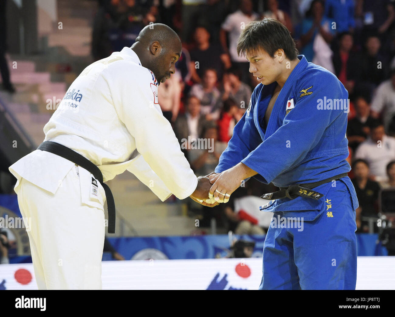 Teddy Riner of France (L) and Ryu Shichinohe of Japan shake hands after ...