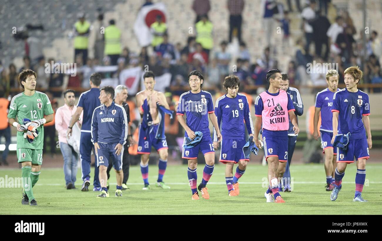 Members of the Japan national soccer team leave the pitch after drawing ...