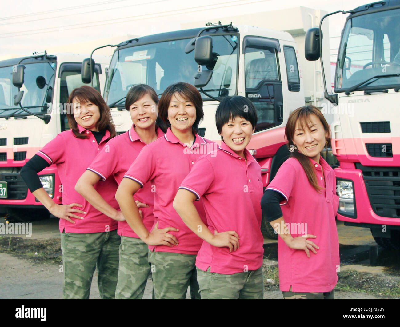 Female truck drivers in pink uniforms pose for photos in Fukui, central ...