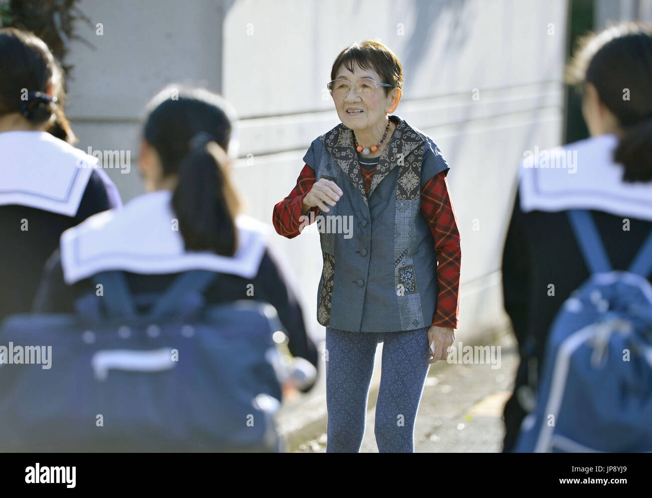 Japanese poet Ko Inoue stands at an intersection near her home in Sakai ...