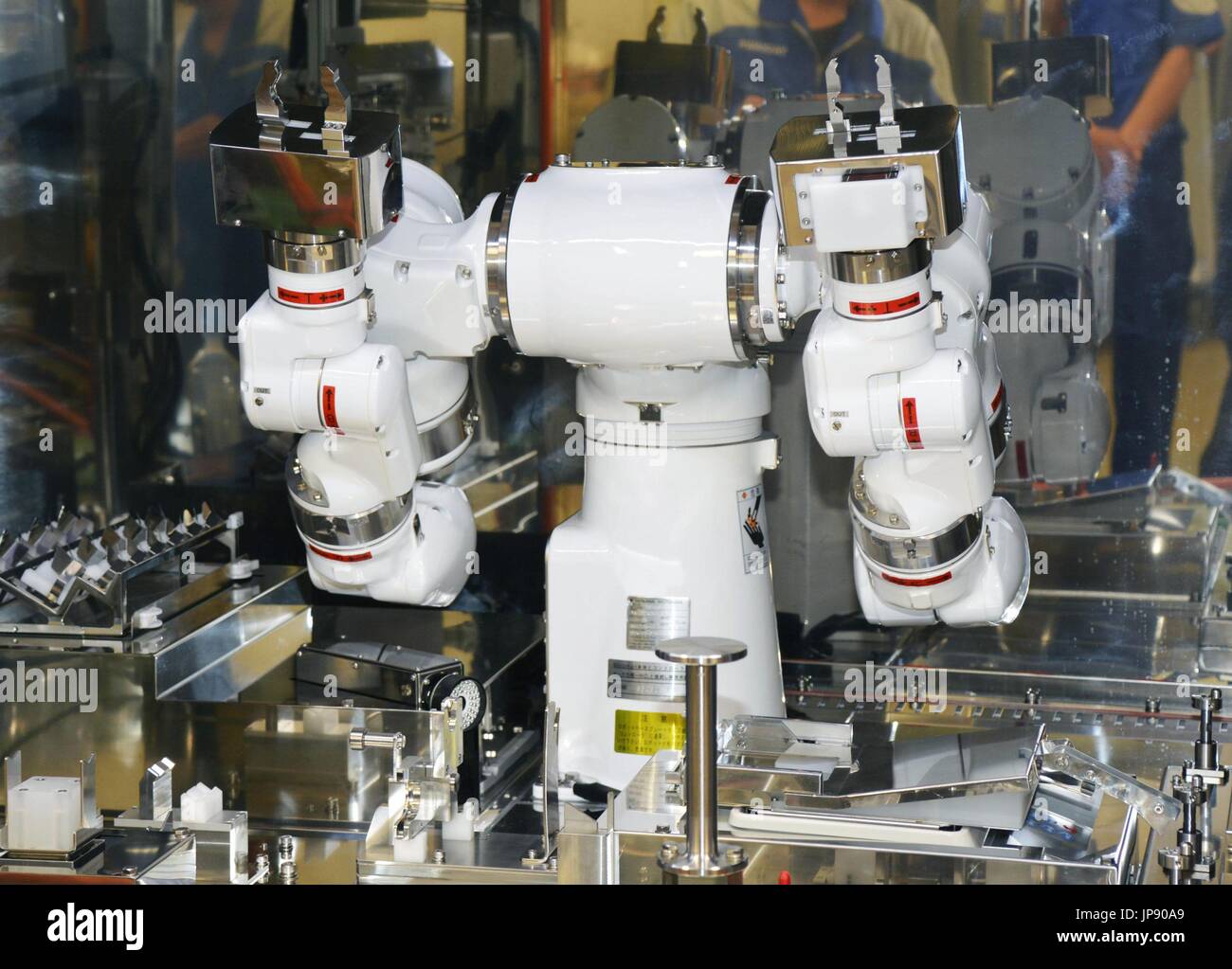 A robotic-arm device developed by Kyushu University and two Japanese ...