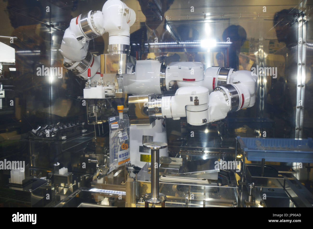 A robotic-armed device developed by Kyushu University and two Japanese ...