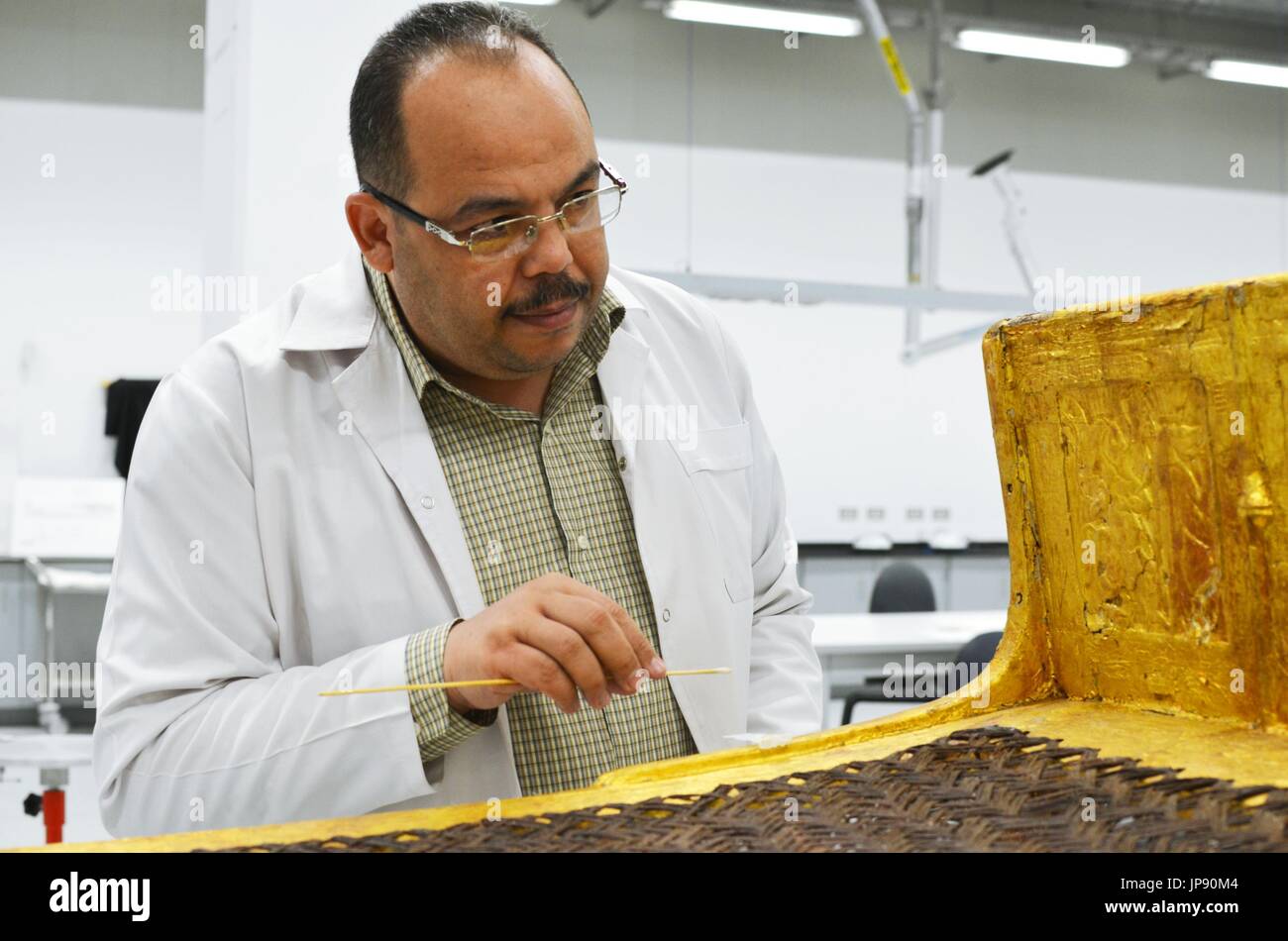 Medhat Abdallah works to preserve the gold-plated bed of King ...