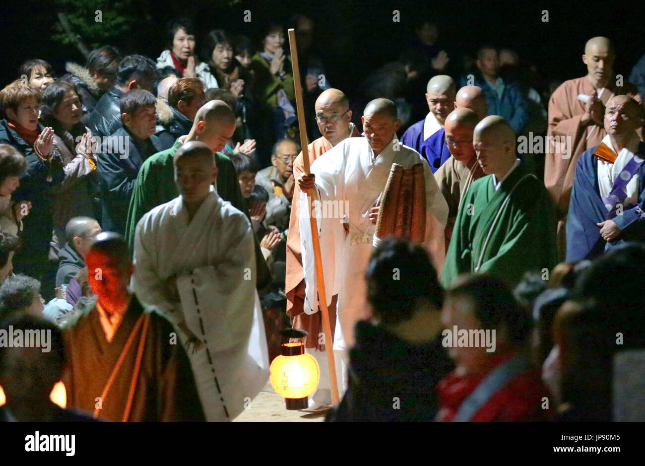 Kogen Kamahori (C), chief priest of a temple in Otsu, walks while being ...