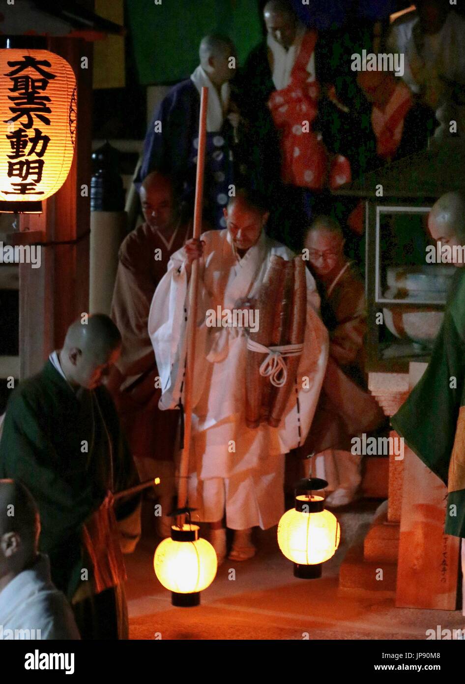Kogen Kamahori (C), chief priest of a temple in Otsu, emerges from a ...