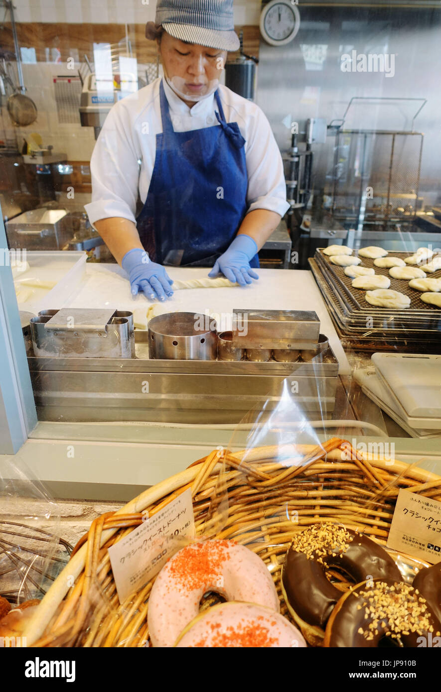 An employee of a Mister Donut shop in the western Japanese city of ...