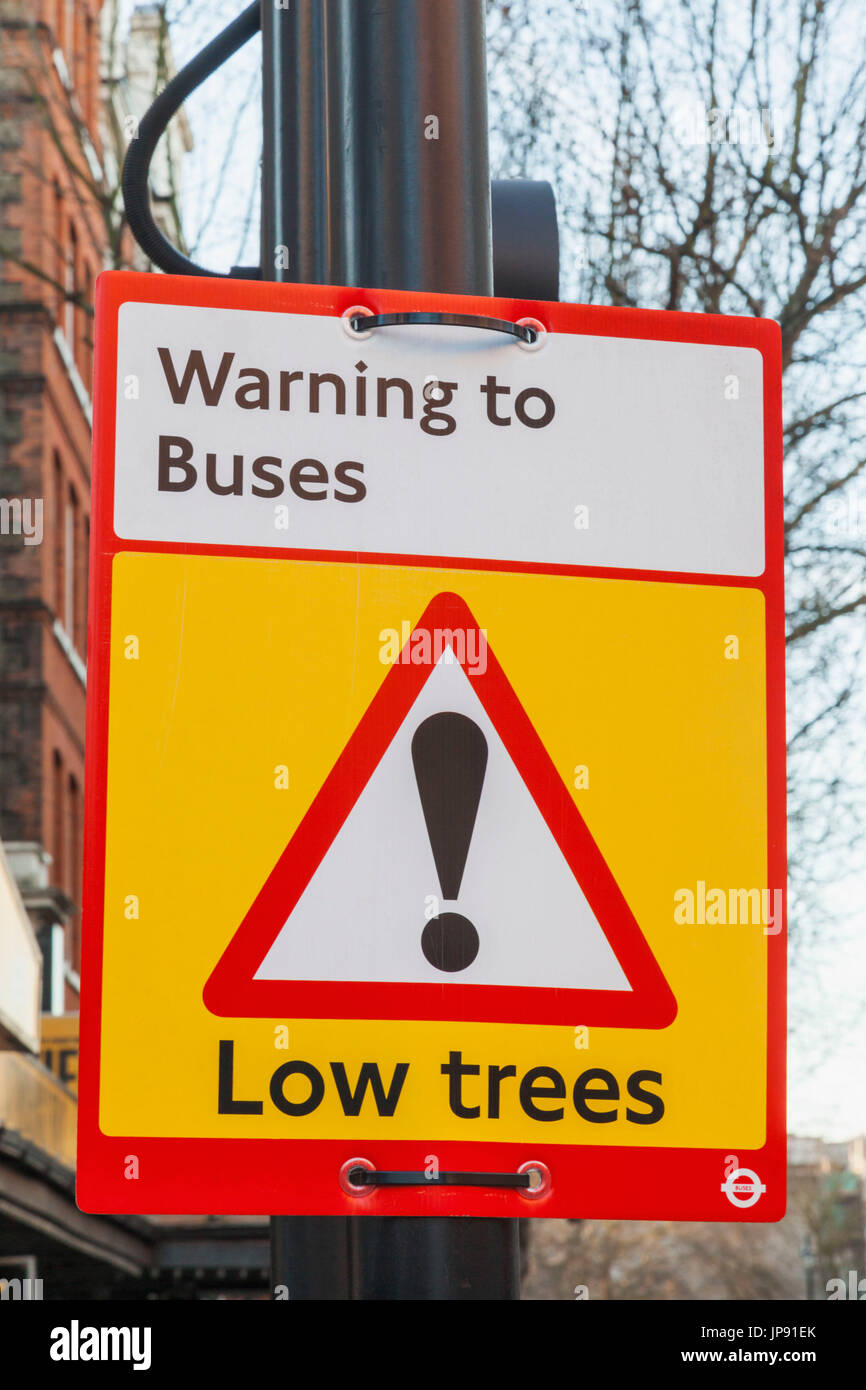 England, London, Low Trees Warning Sign for Buses Stock Photo - Alamy