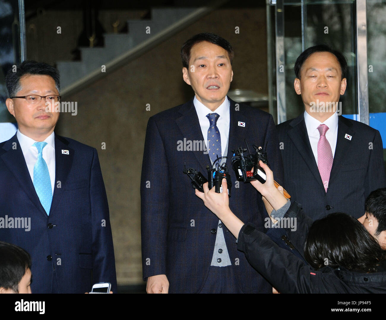 South Korean Unification Ministry official Kim Ki Woong (C), director ...