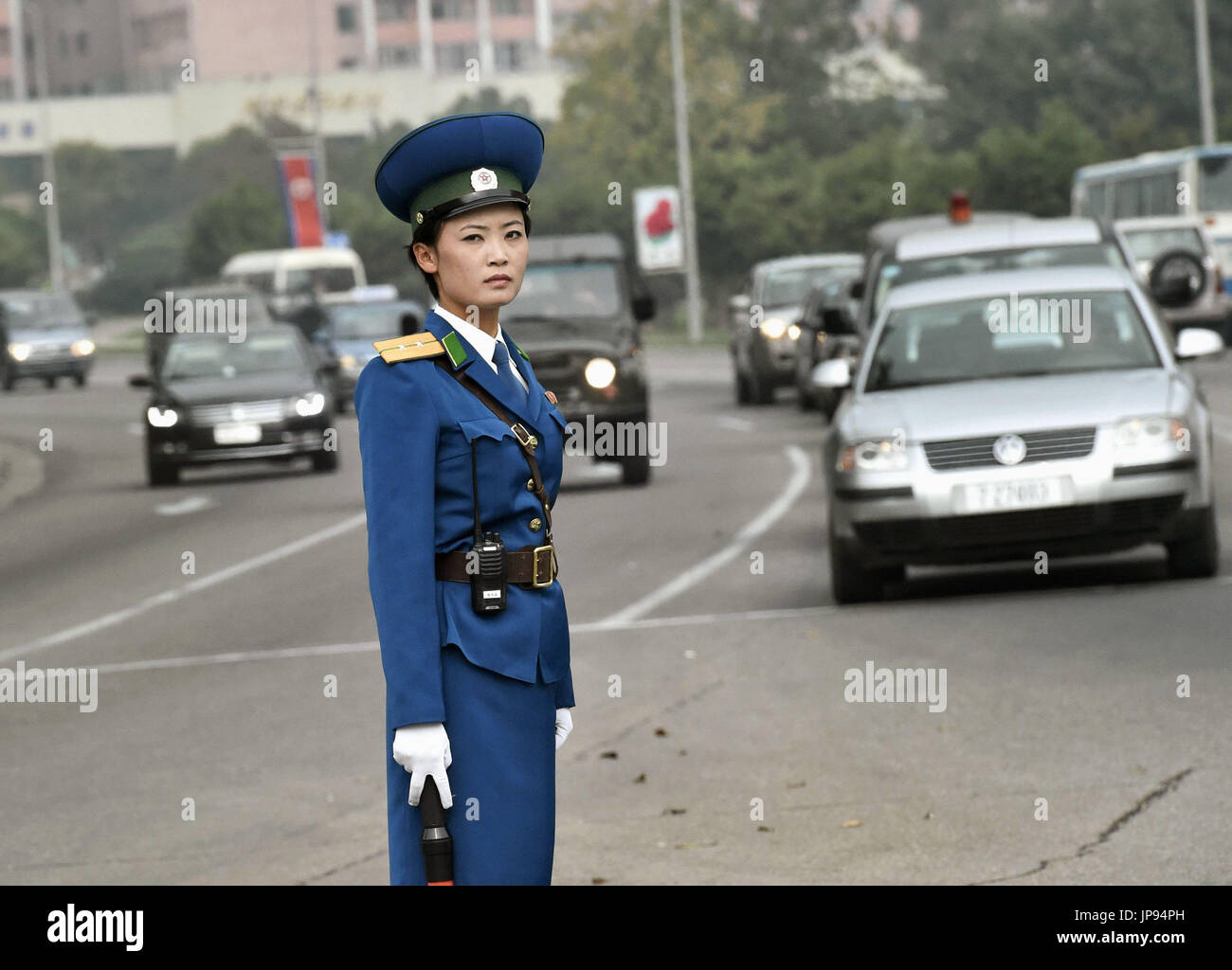 A female police officer controlling traffic on the streets of Pyongyang ...