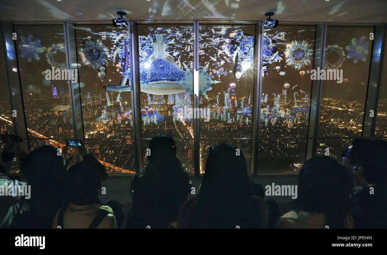 Visitors view projection mapping at the observation deck of Japan's ...