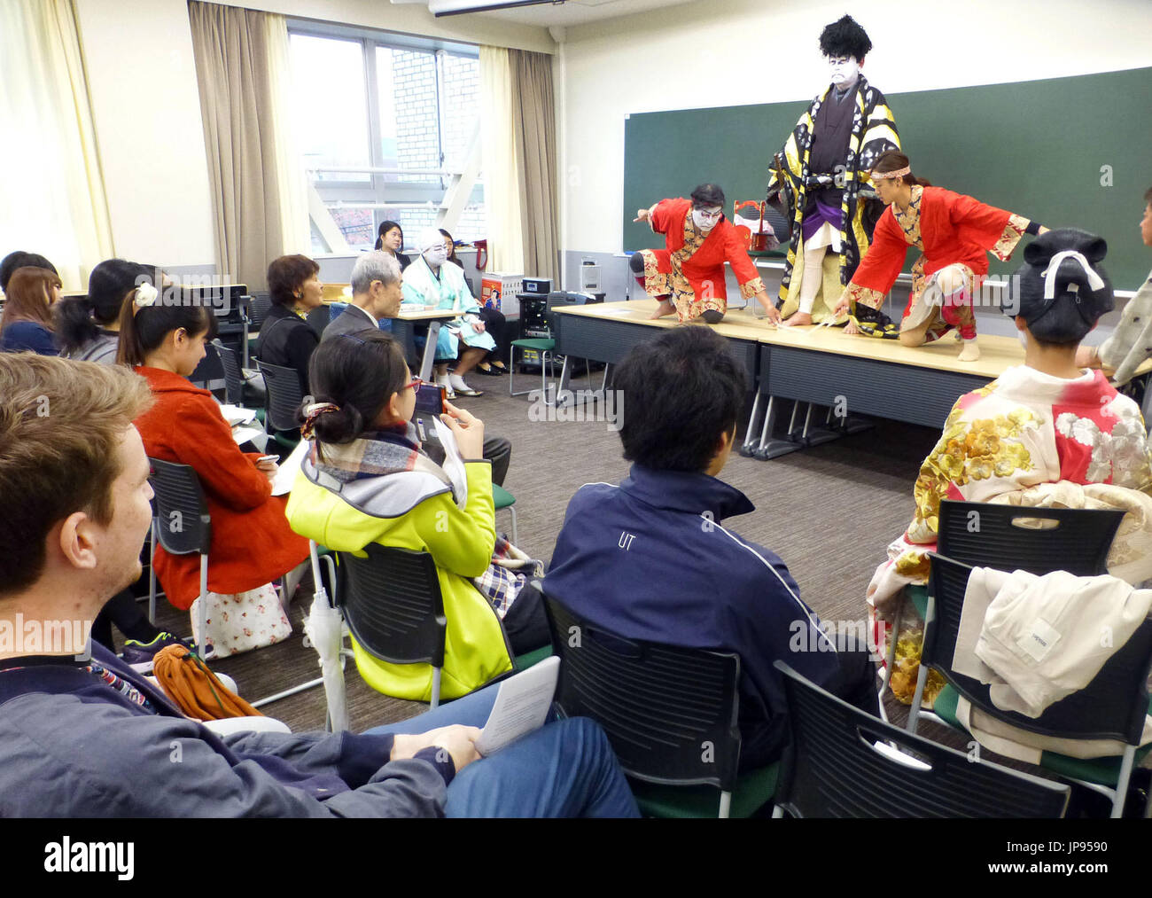 A group of foreign students enjoys a traditional Japanese Kabuki ...