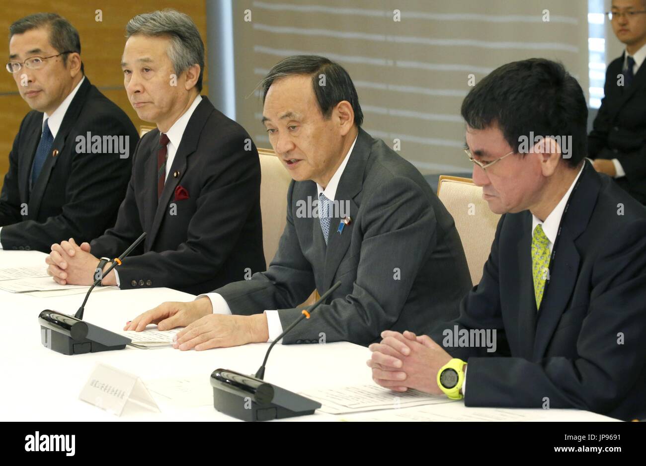 Chief Cabinet Secretary Yoshihide Suga (3rd from L) speaks during a ...