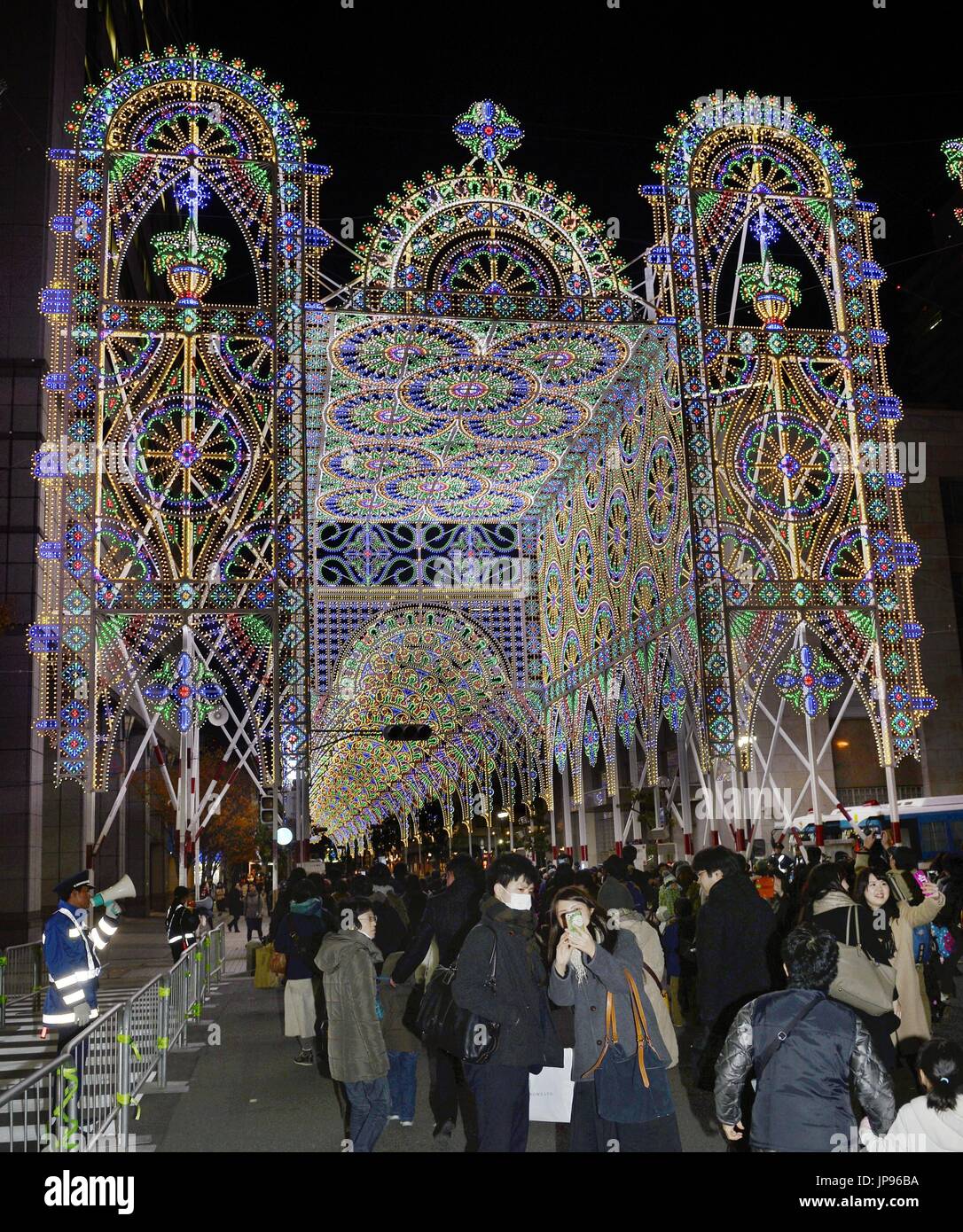Photo shows people walking through an illuminated structure at the ...