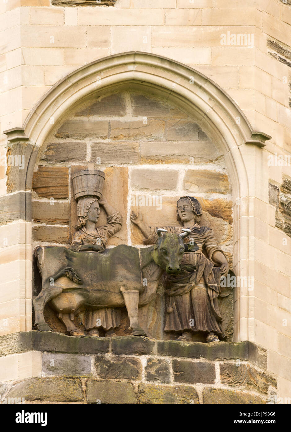 The 18th century Dun Cow and milkmaids sculpture on the north facade of ...