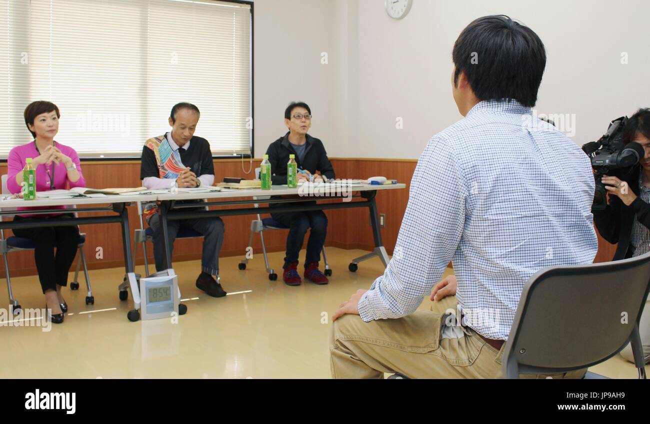 An applicant (front) undergoes a job interview in plain clothes at the ...