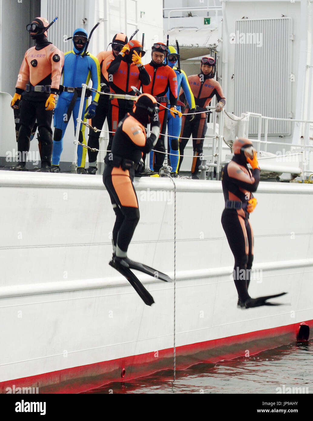 Japanese police and coast guard personnel conduct a joint diving drill ...