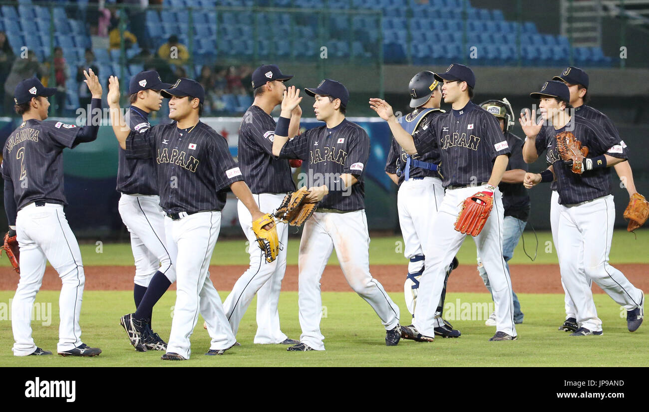 Japanese baseball players exchange high-fives after beating the United ...