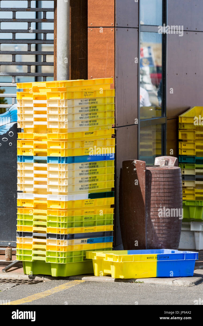 colorful boxes plastic crates. Packing containers piles for fish ...