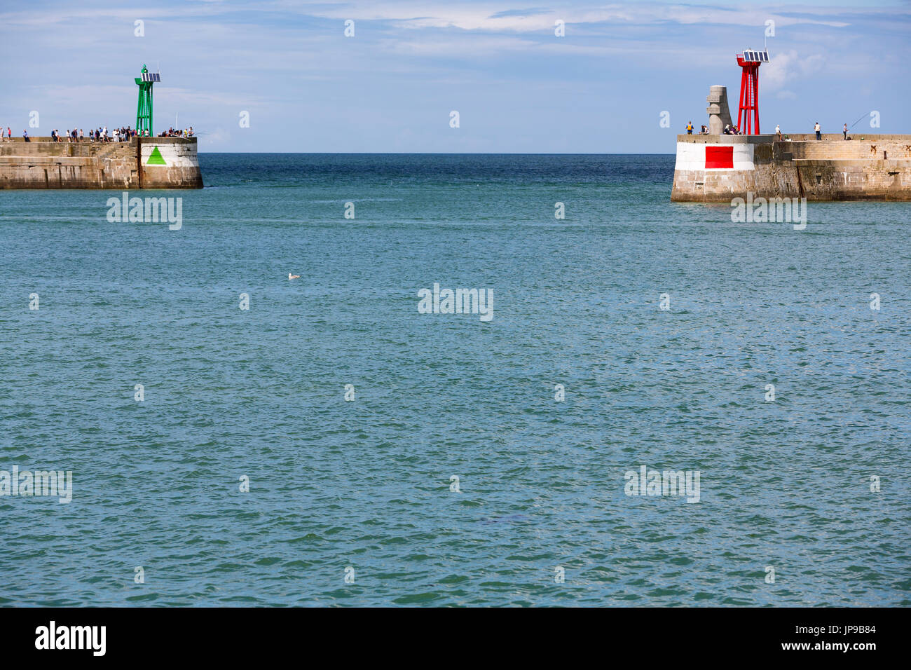 Seawall with red and green lighthouses in Fance, Normandy Stock Photo ...