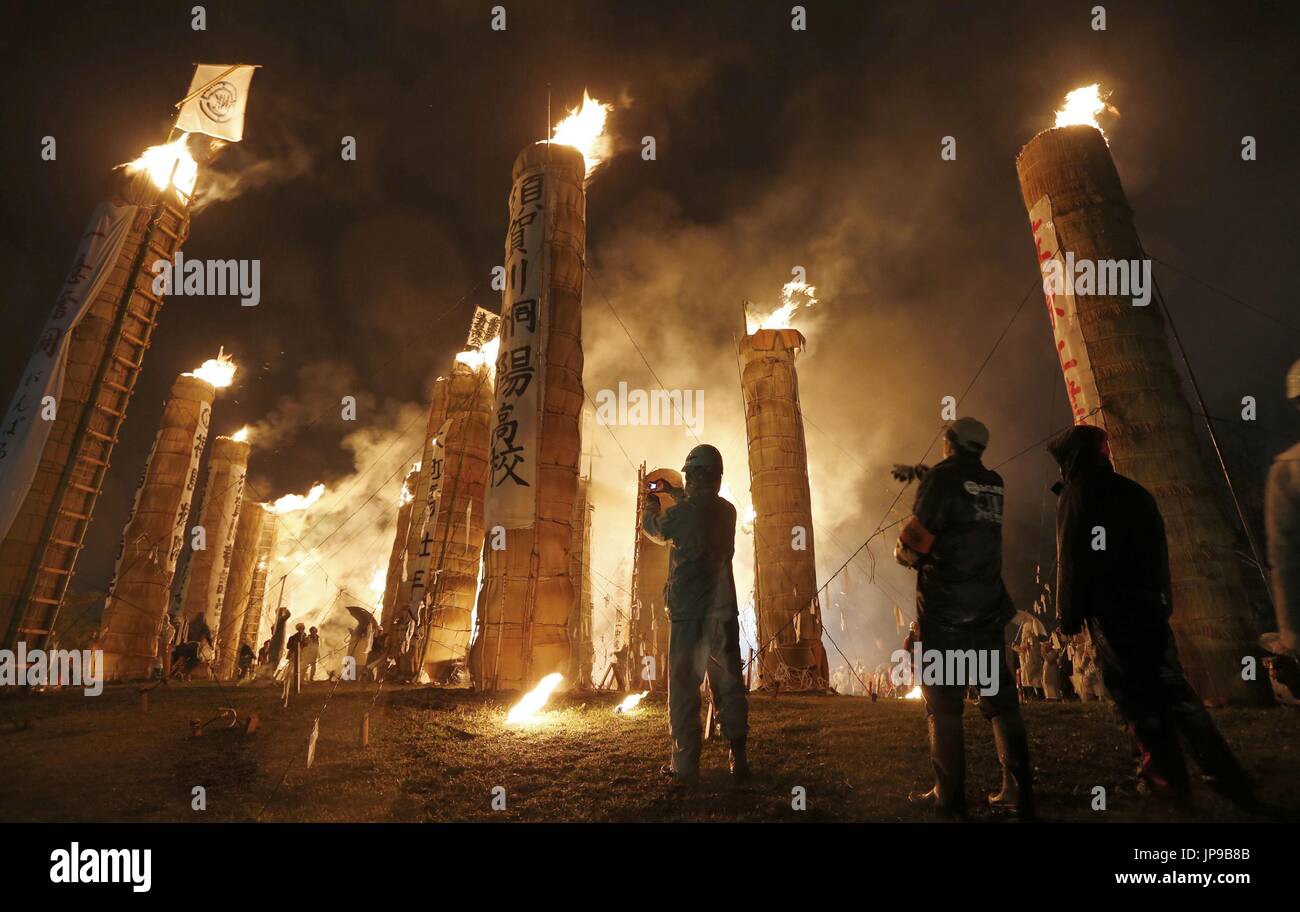 About 25 giant torches blaze at the traditional "Taimatsu Akashi ...