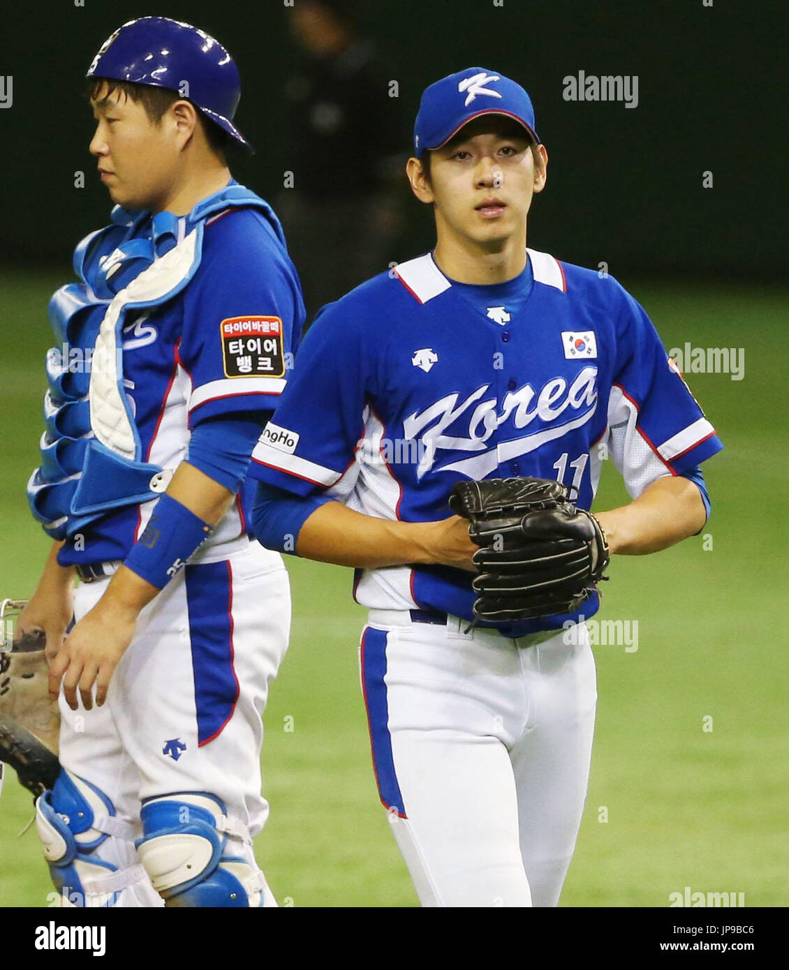 South Korea starting pitcher Rhee Dae Eun (R) is taken out of the game ...