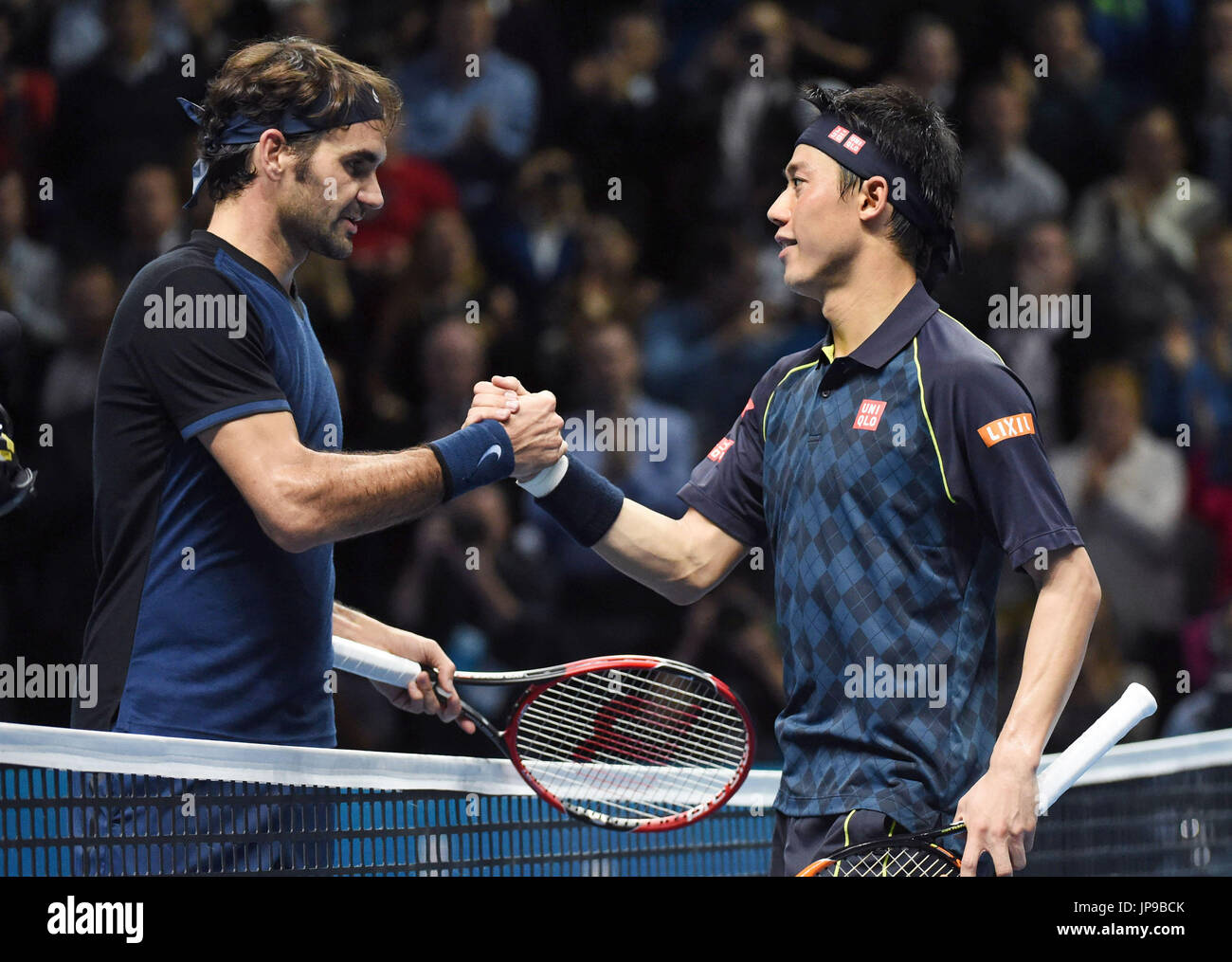 Roger Federer (L) and Kei Nishikori shake hands after their group-stage ...