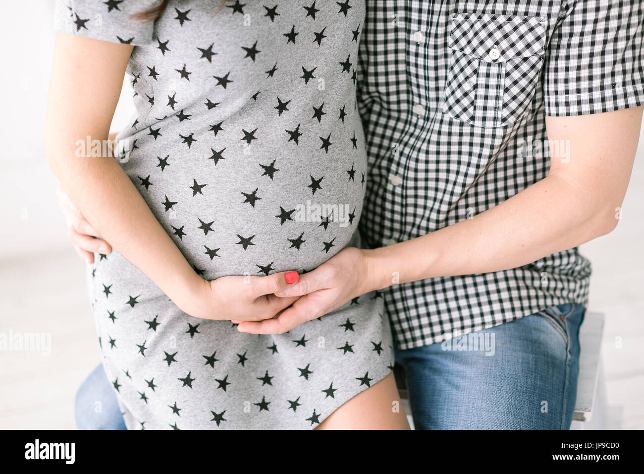 pregnancy, motherhood, birth of children concept - closeup on round ...