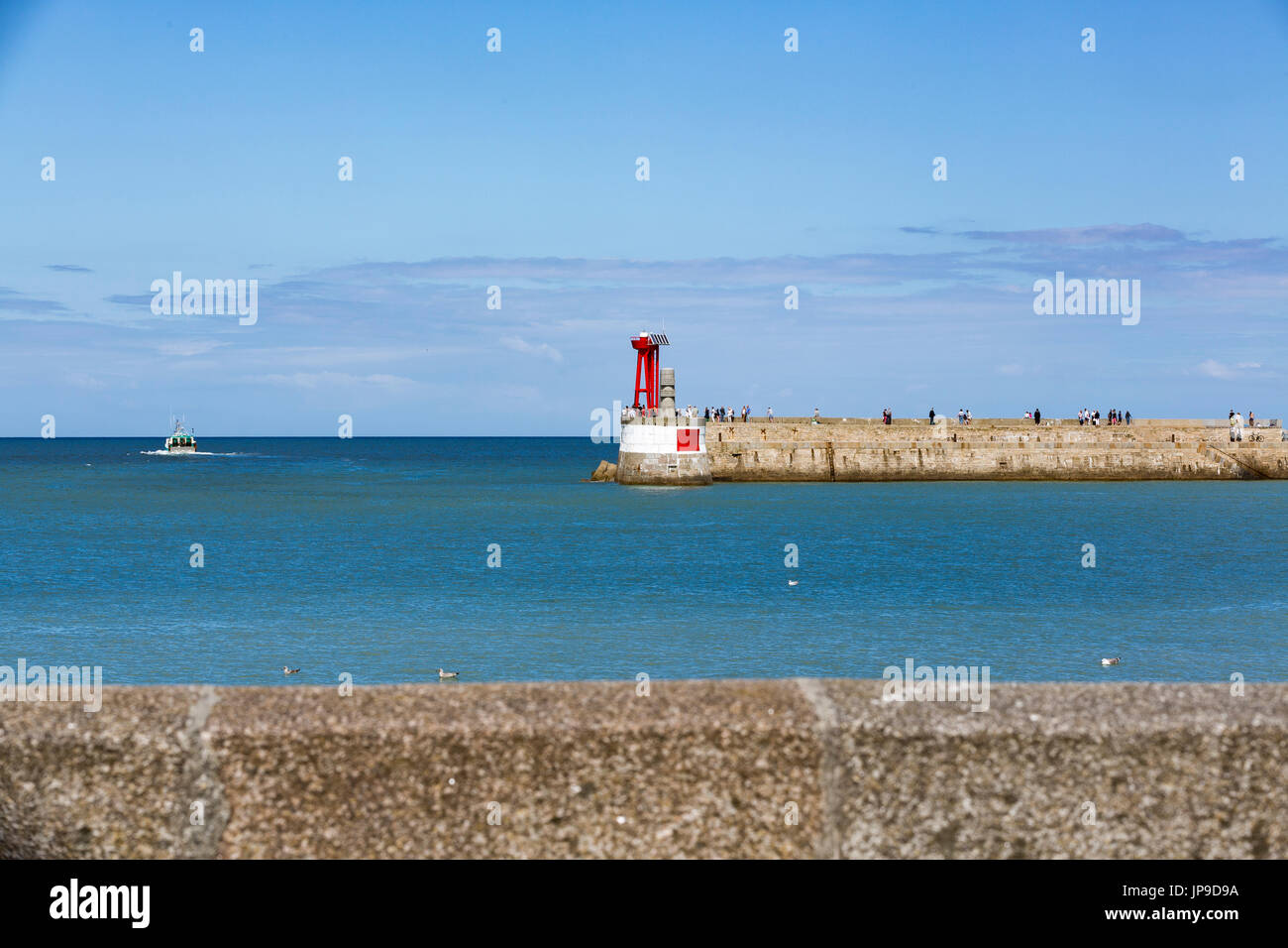 Seawall with red and green lighthouses in Fance, Normandy Stock Photo ...