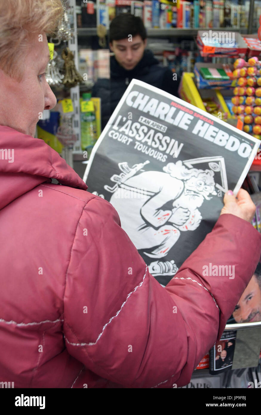 A woman holds a special edition of Charlie Hebdo, a French satirical ...