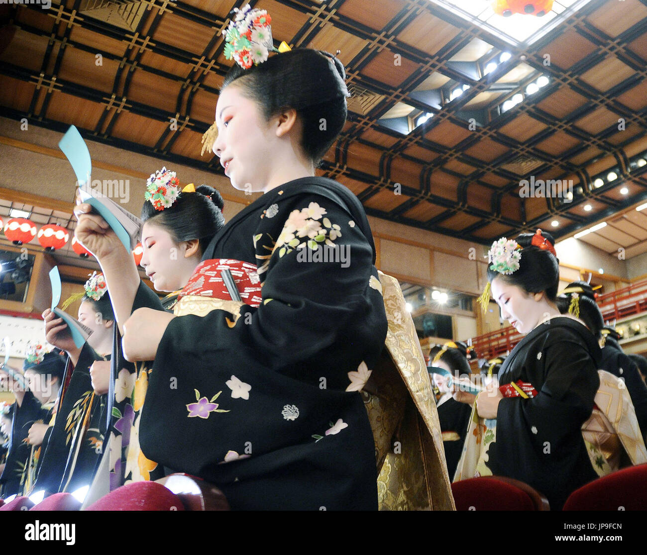 Maiko, or apprentice "geisha," wearing family crest-bearing kimono ...