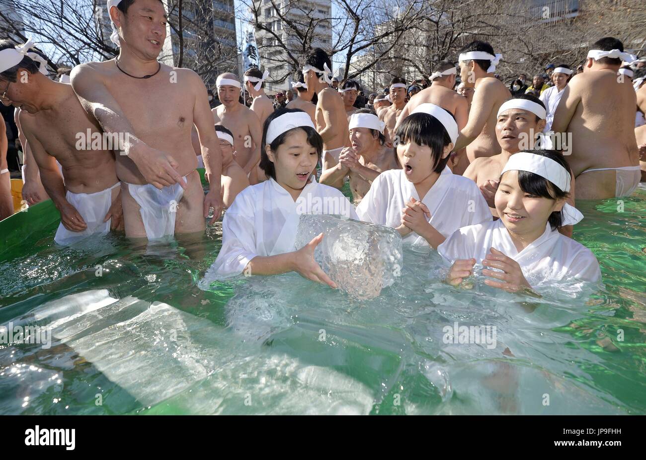 People bathe in ice water at Teppozu Inari Shrine in Tokyo on Jan. 10 ...