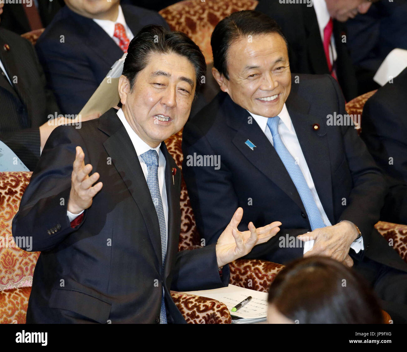 Japanese Prime Minister Shinzo Abe (L) and Finance Minister Taro Aso ...