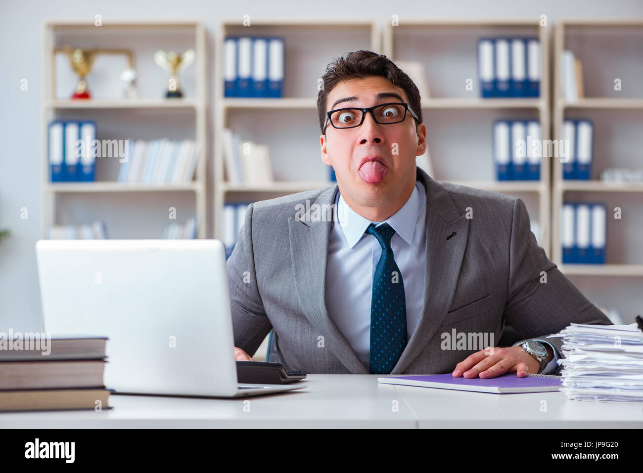 Funny businessman clown acting silly in the office Stock Photo - Alamy
