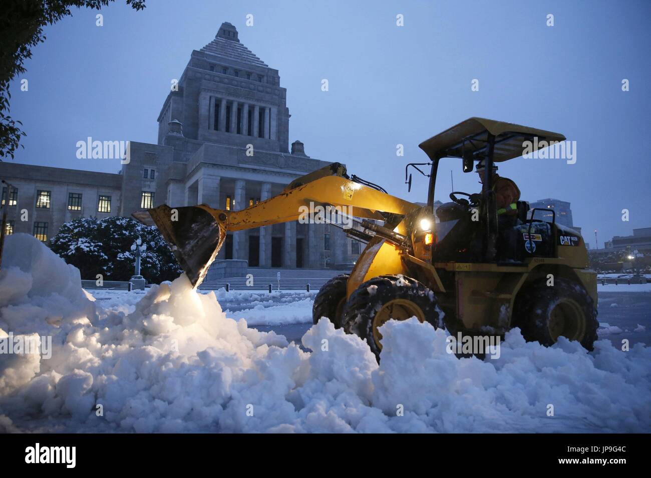 A snow plow removes snow in front of the parliamentary building in ...