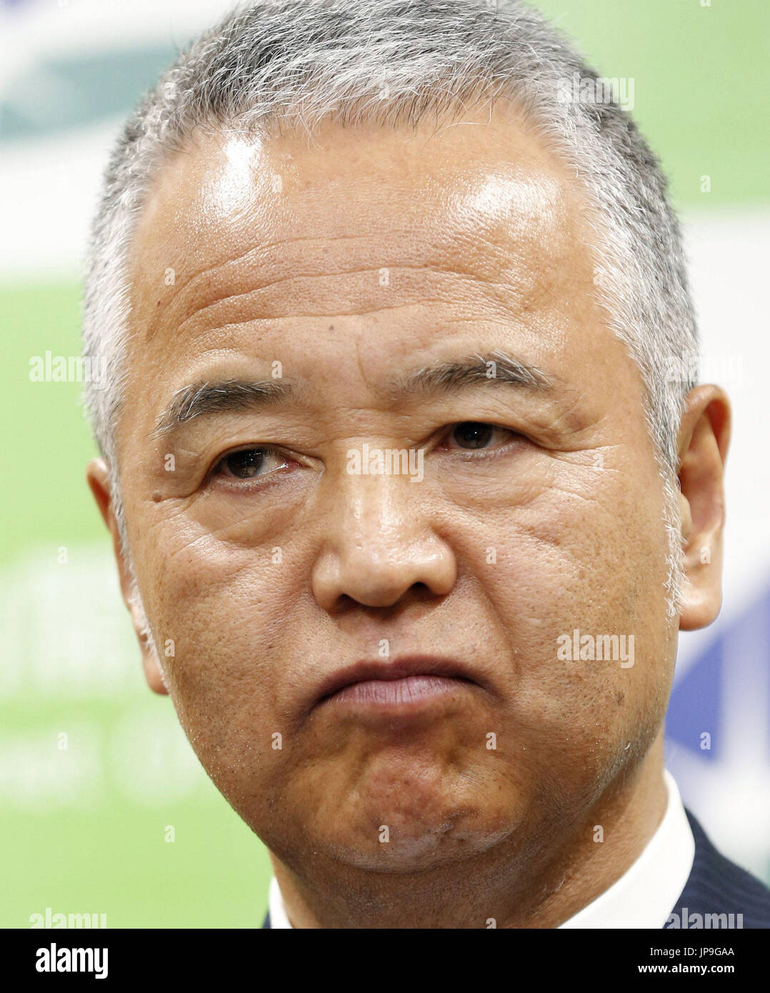 Economy and Fiscal Policy Minister Akira Amari listens to a reporter's ...