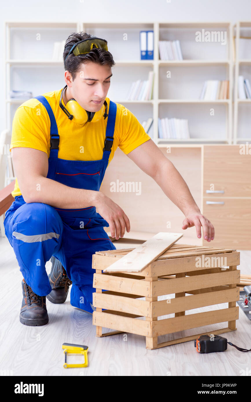 Repairman carpenter inspecting examining a wooden board plank Stock ...