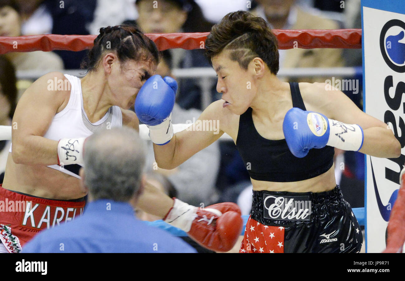 Japan's Etsuko Tada (R) punches Mexican Kareli Lopez in the face in an IBF women's world mini ...