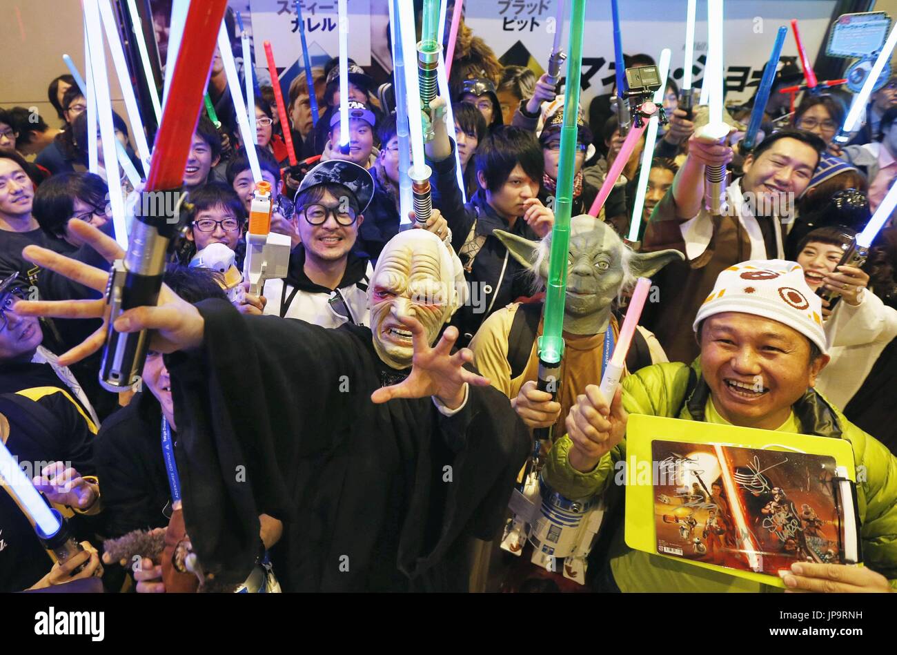 Fans in costumes wait in front of a movie theater in Tokyo to see "Star ...