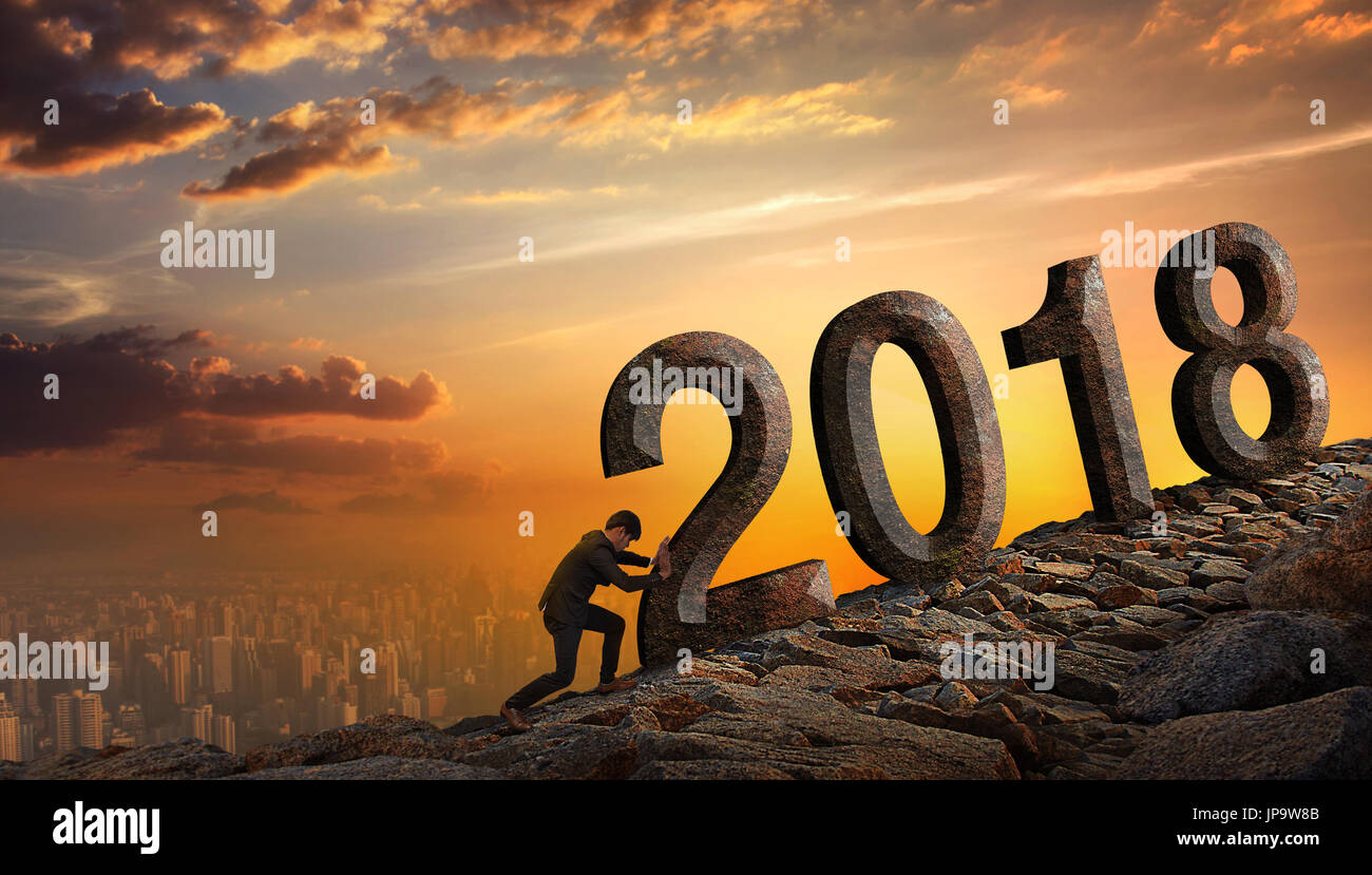 Business man pushing large stone up to hill with numbers 2018 ...